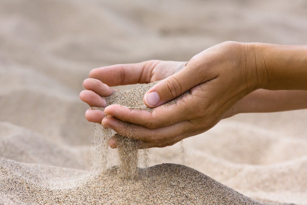 sand running through hands of woman - KnowledgePoint KnowledgePoint